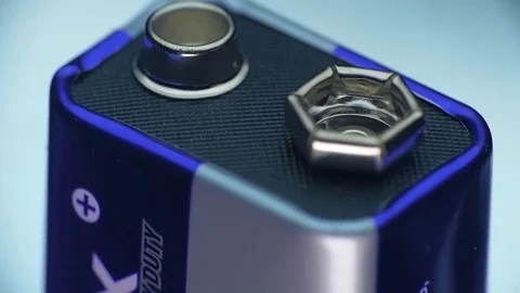 Blue 9-volt battery rotate on a white ba... | Stock Video | Pond5