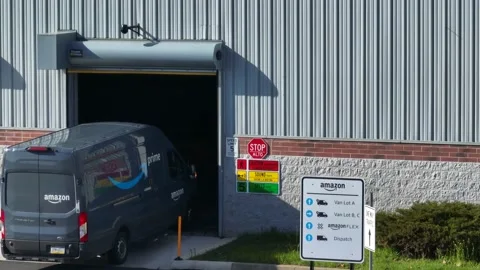 Blue Amazon van with smile logo enters w... | Stock Video | Pond5