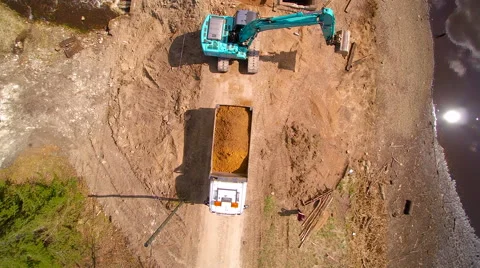 The blue backhoe digging the land in an ... | Stock Video | Pond5