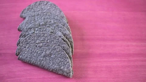 Blue corn taco shells on a pink backgrou... | Stock Video | Pond5