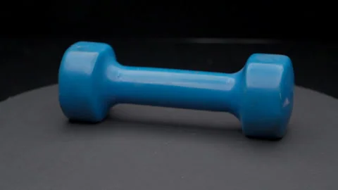 Blue exercise fitness dumbbell rotating ... | Stock Video | Pond5