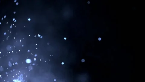 Blue glowing flying embers burning on bl... | Stock Video | Pond5