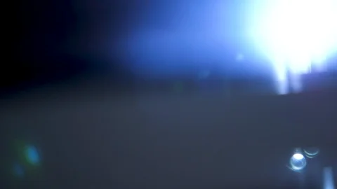 Blue lens flare blinking over black back... | Stock Video | Pond5