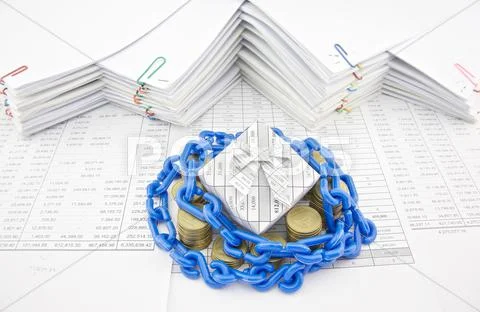 Photograph: Blue plastic chain shackle gift box and pile gold coins ...