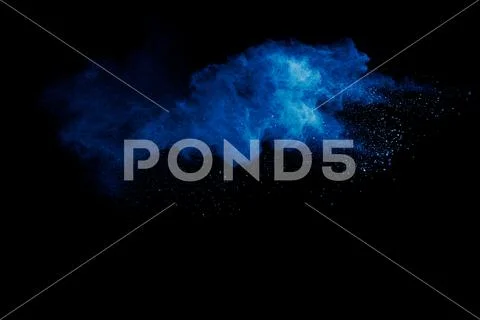 Blue powder explode cloud on black background.Launched blue dust ...