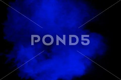 Blue powder explosion cloud on black background.Launched blue dust ...