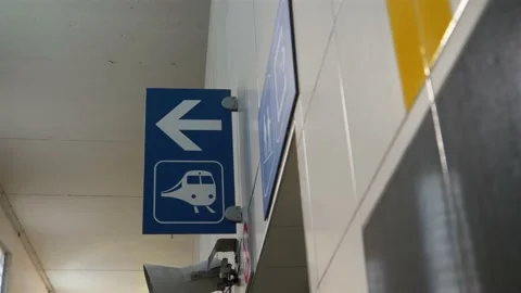 Blue sign in train station pointing to t... | Stock Video | Pond5