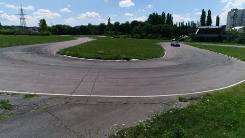 Blue sports car turns on a track outside... | Stock Video | Pond5