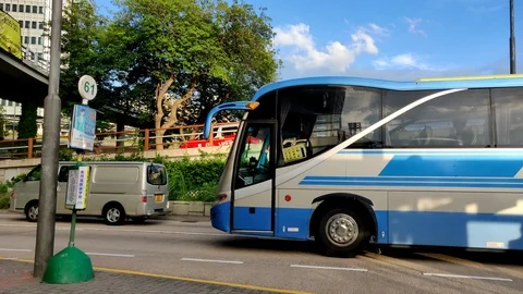 Blue travel bus passing by bus station i... | Stock Video | Pond5