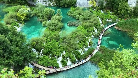 Blue water lakes. People walking in nati... | Stock Video | Pond5