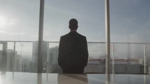 Blurred Businessman in Suit Looks Out Hi... | Stock Video | Pond5