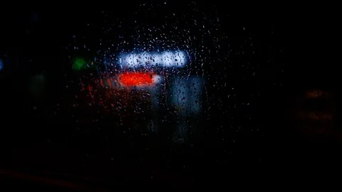 Blurred rain drops at car window and nig... | Stock Video | Pond5
