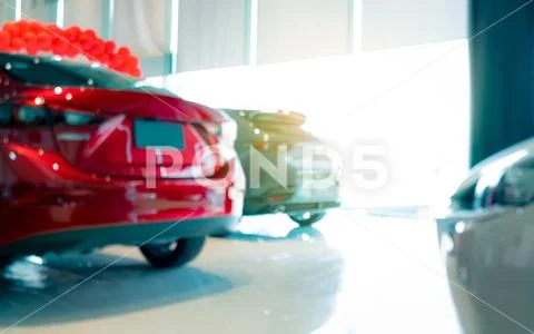 Blurred rear view of red car. Luxury car parked in modern showroom. Car ...