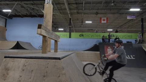 BMX peg tricks on a wooden ramp sub rail | Stock Video | Pond5