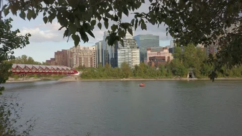 Boat in Bow River Calgary downtown skysc... | Stock Video | Pond5