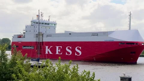 Boat next to Kess cargo ship sailing thr... | Stock Video | Pond5