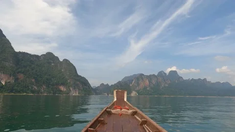 Boat riding through mountain lake at Kha... | Stock Video | Pond5