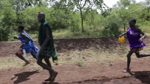 Bodi tribe girl running along a car, Han... | Stock Video | Pond5