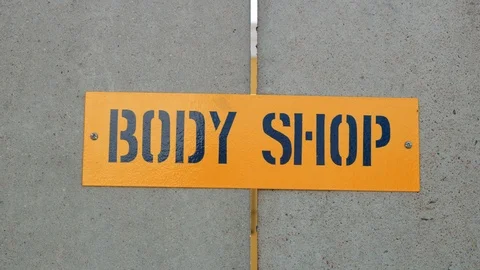 Body Shop Sign on a Yellow Plate Mounted... | Stock Video | Pond5