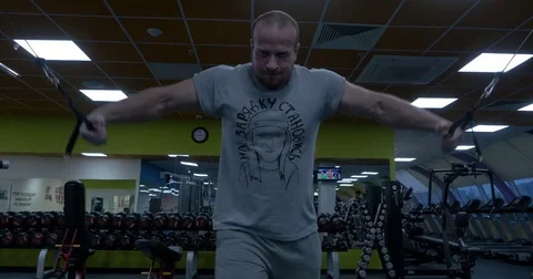 Bodybuilder doing butterfly on cable pul... | Stock Video | Pond5