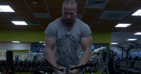 Bodybuilder doing butterfly on cable pul... | Stock Video | Pond5