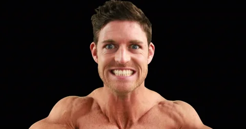 Bodybuilder flexing for the camera | Stock Video | Pond5