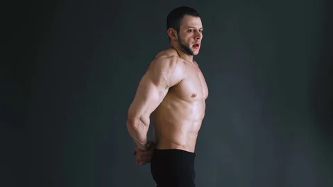 bodybuilder flexing his muscles at studi... | Stock Video | Pond5