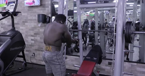 Bodybuilder with great physique in a gym | Stock Video | Pond5