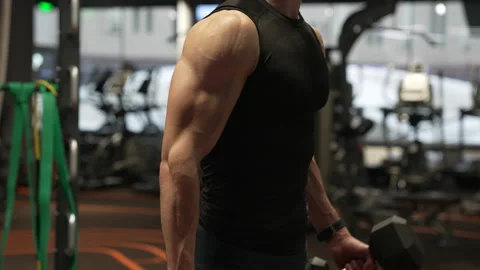 Bodybuilder man crop view doing biceps t... | Stock Video | Pond5