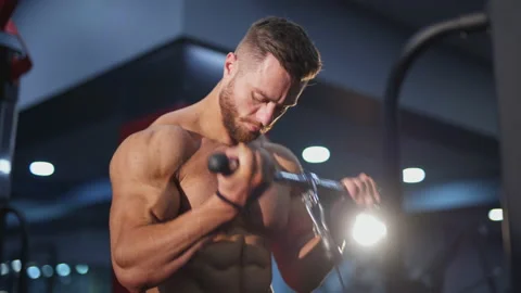 Bodybuilder pumping arm muscles. Handsom... | Stock Video | Pond5