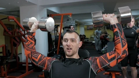 Bodybuilder pumping muscle in the gym, d... | Stock Video | Pond5
