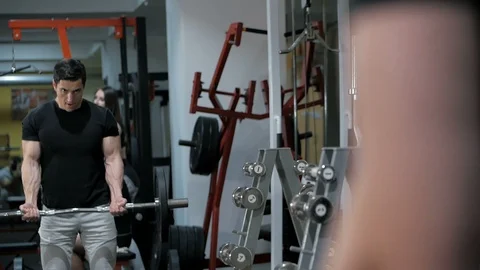 Bodybuilder pumping muscle in the gym, d... | Stock Video | Pond5