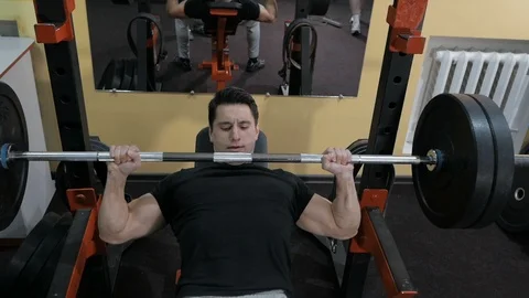 Bodybuilder pumping muscle in the gym, d... | Stock Video | Pond5
