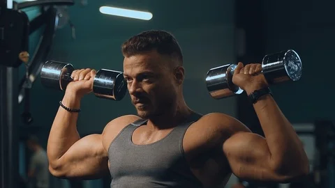 Bodybuilder pumping up muscles workout f... | Stock Video | Pond5