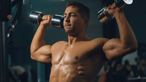 Bodybuilder pumping up muscles workout f... | Stock Video | Pond5