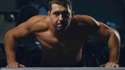 Bodybuilder pumping up muscles workout f... | Stock Video | Pond5