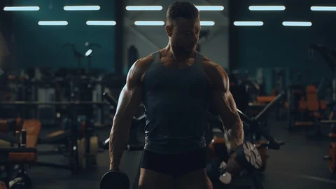 Bodybuilder pumping up muscles workout f... | Stock Video | Pond5