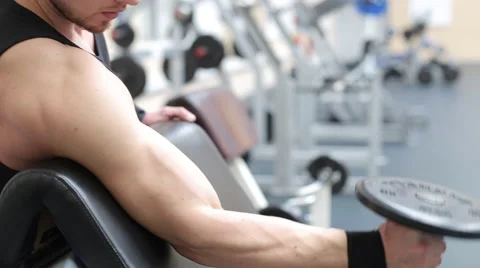 Bodybuilder shakes his biceps at the gym | Stock Video | Pond5