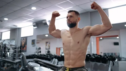 The bodybuilder tenses his muscles, look... | Stock Video | Pond5