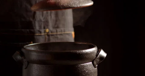 A boiling clay pot steams up as a chef o... | Stock Video | Pond5