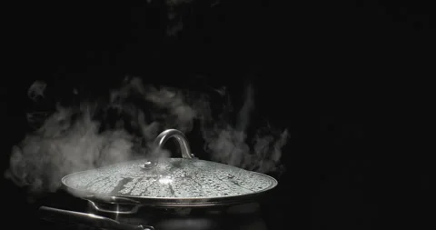 Boiling water in pan. Steam rising from ... | Stock Video | Pond5