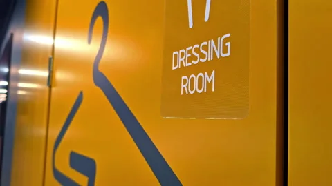 Bold yellow dressing room sign with hang... | Stock Video | Pond5