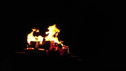 A bonfire is burning on a dark backgroun... | Stock Video | Pond5