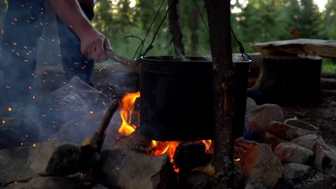 Bonfire cooking. Pot with smoke over cam... | Stock Video | Pond5