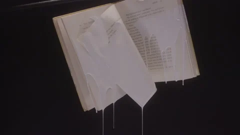 Book Pages Dripping White Paint in a Stu... | Stock Video | Pond5