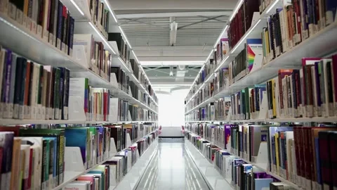 Books on bookshelves in modern universit... | Stock Video | Pond5