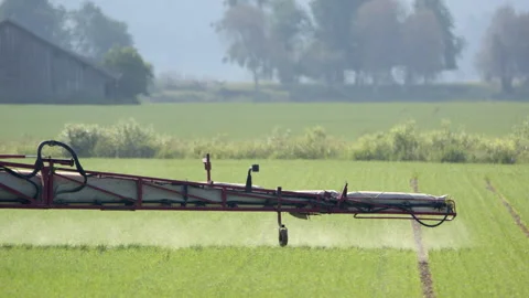 Boom arm of sprayer tractor spraying ins... | Stock Video | Pond5
