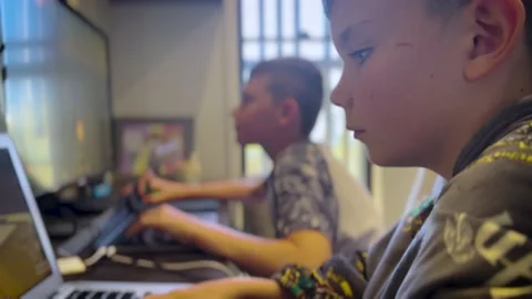 Bored kids playing video games on comput... | Stock Video | Pond5