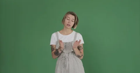 Bored woman clapping hands over green ba... | Stock Video | Pond5