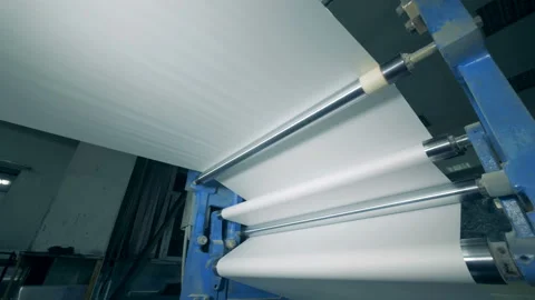 Bottom view of white paper rolling throu... | Stock Video | Pond5